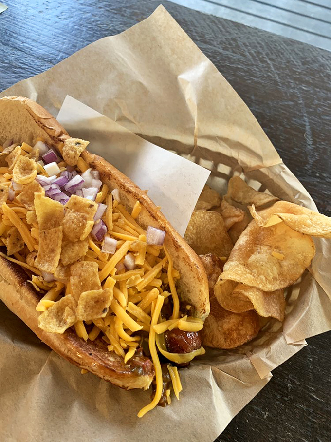 The holy grail of comfort food&mdash;a chili dog topped with melted cheese, crunchy chips, and diced onions that would make your cardiologist wince and your taste buds sing.