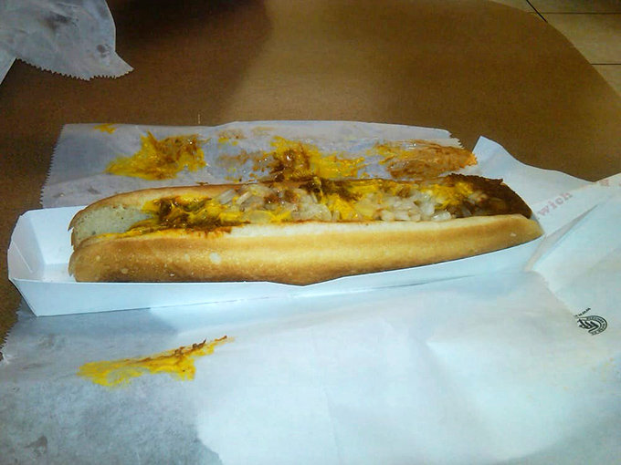 The humble hot dog, elevated to art form. Nestled in a soft bun and smothered with chili and cheese&mdash;proof that simplicity can be spectacular.