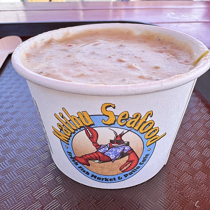 Creamy clam chowder that would make a New Englander weep with joy, served in a cup that promises comfort with every steaming spoonful.