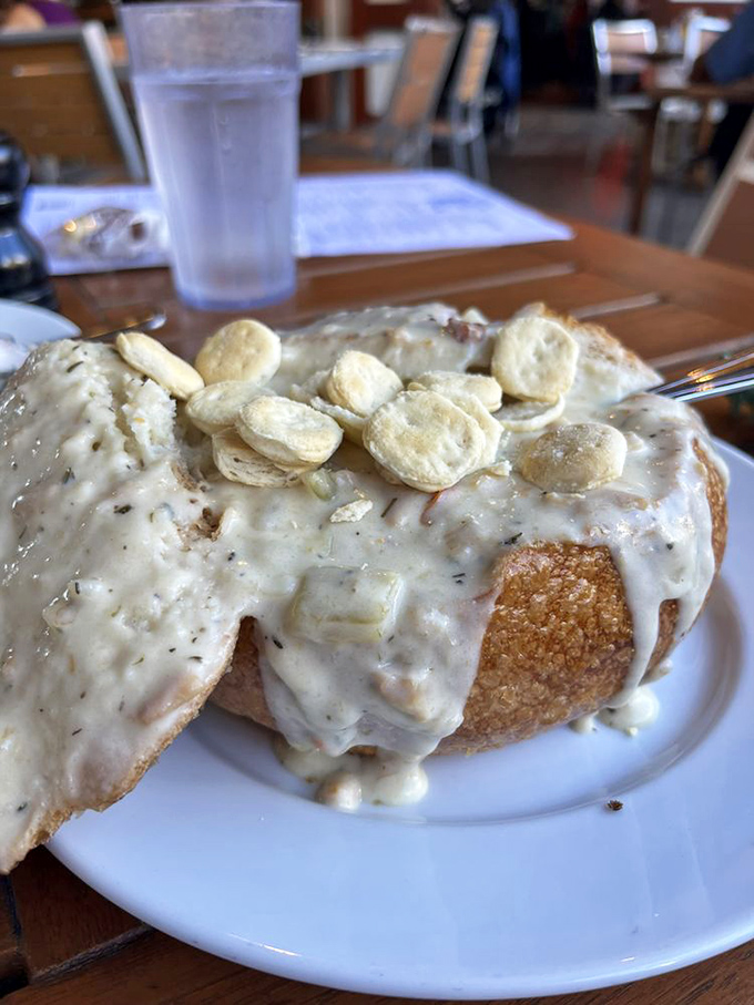 Behold the bread bowl battlefield—where your spoon wages a delicious war against creamy chowder topped with oyster crackers.