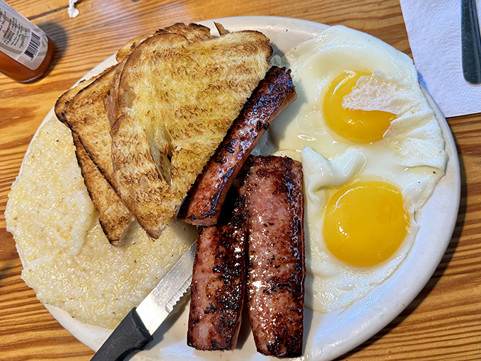 The breakfast trinity: perfectly sunny eggs, sausage with attitude, and grits that would make any Northerner finally understand the appeal.