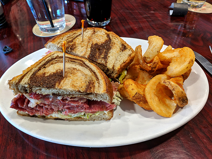 This isn't just a sandwich; it's architecture. Layers of corned beef stacked between marble rye with those gloriously thick-cut pub chips.