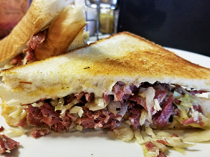Behold the Reuben's cooler cousin – layers of house-made corned beef and tangy slaw creating a sandwich that demands to be eaten with both hands and zero shame.