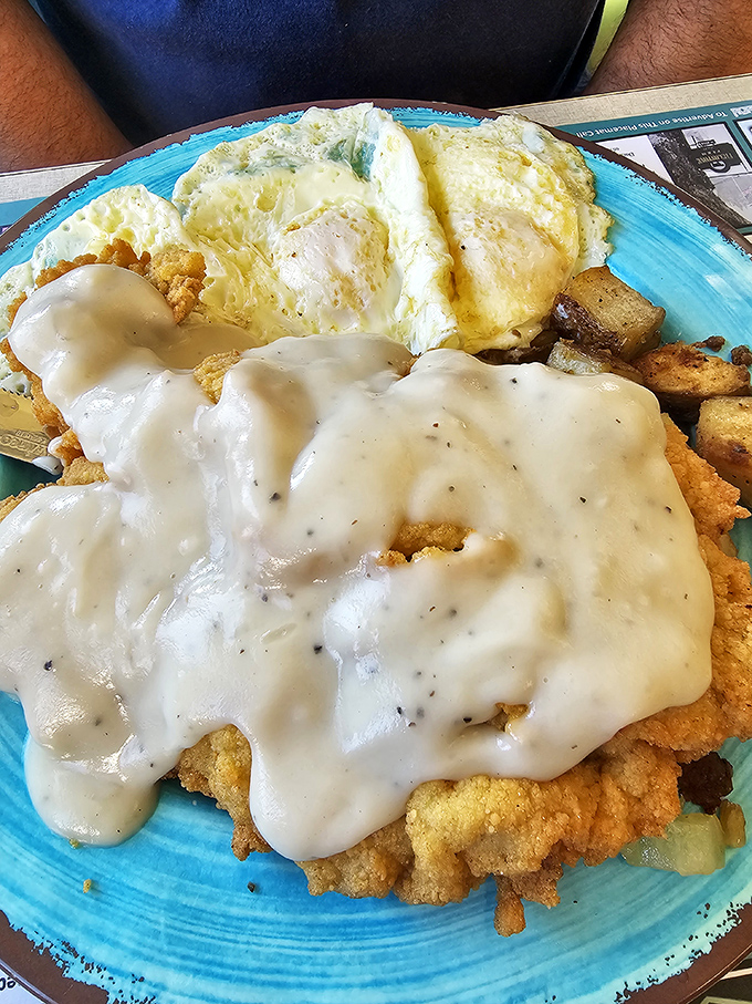 Country fried steak smothered in peppery gravy with eggs sunny-side up &ndash; breakfast doesn't get more satisfying than this hearty plate.