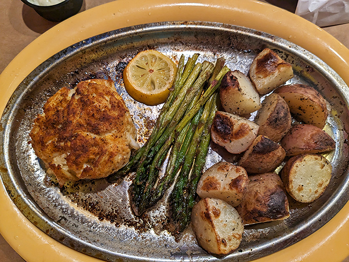 The holy grail of Maryland cuisine: a perfectly bronzed crab cake with roasted potatoes and asparagus. Minimalist plating that lets quality speak for itself.