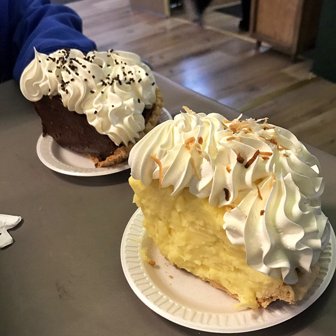 The chocolate and coconut cream pies sit side by side like old friends, each topped with a cloud of whipped cream that defies gravity.