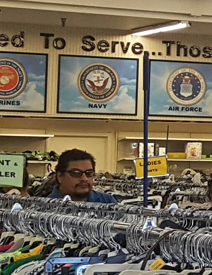Beneath military service emblems, shoppers hunt for treasures while honoring veterans. Retail therapy with a side of patriotism.