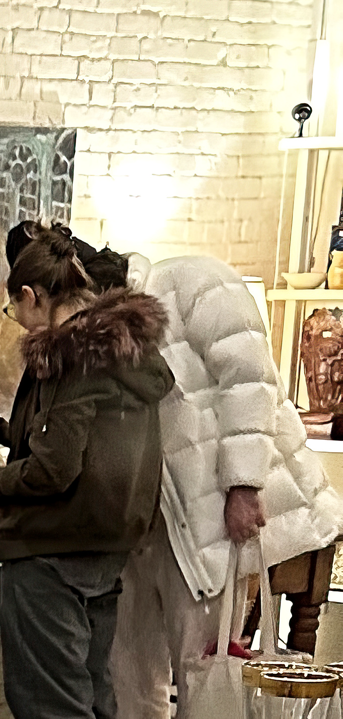 Treasure hunters examine unique finds against the store's signature white brick walls&mdash;the thrill of discovery is palpable.