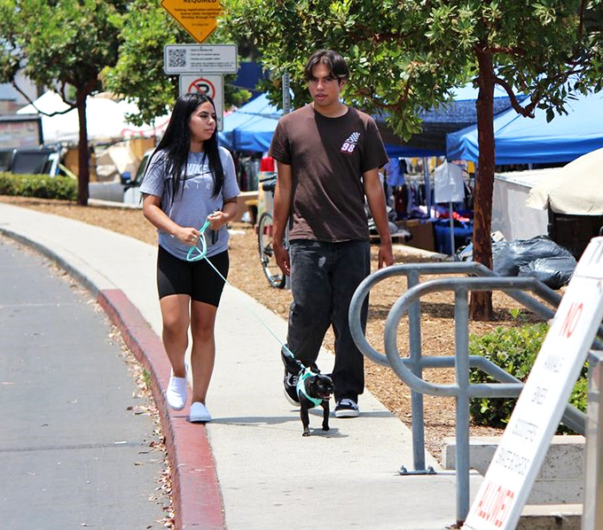 Young shoppers and their four-legged friend explore the perimeter of the market, proving the swap meet is truly fun for the entire family.