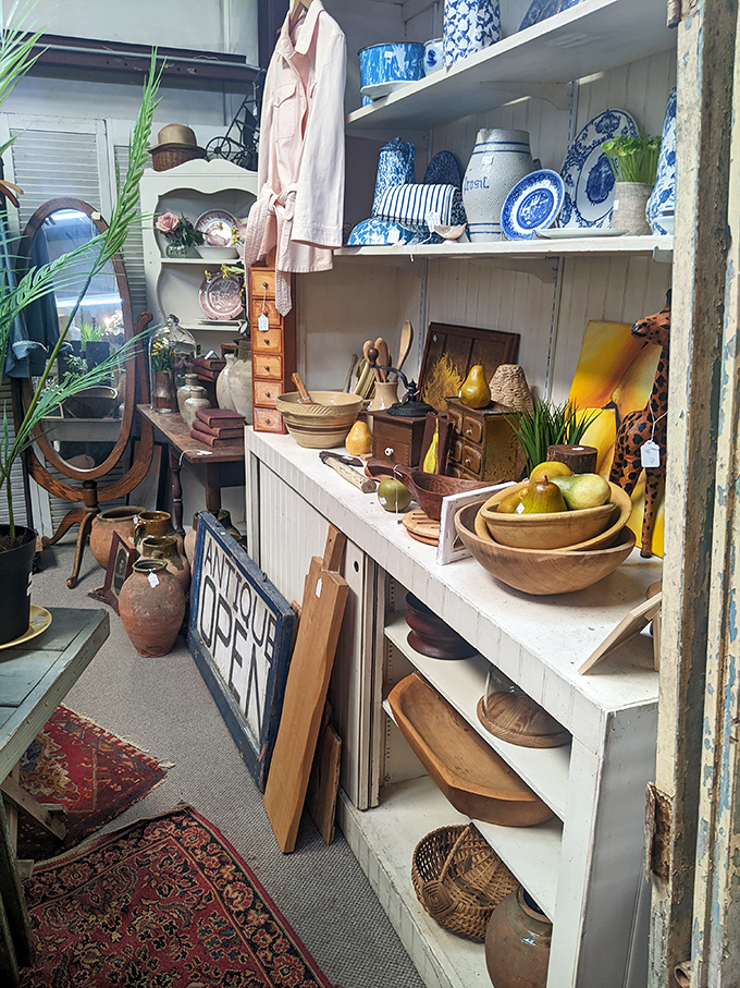 Wooden bowls, blue pottery, and vintage treasures create a decorator's playground where rustic meets refined.