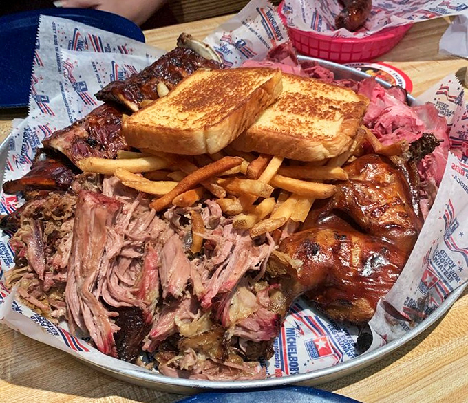 The BBQ platter that launched a thousand napkins. Pulled pork, ribs, and all the fixings create a symphony of smoky satisfaction.