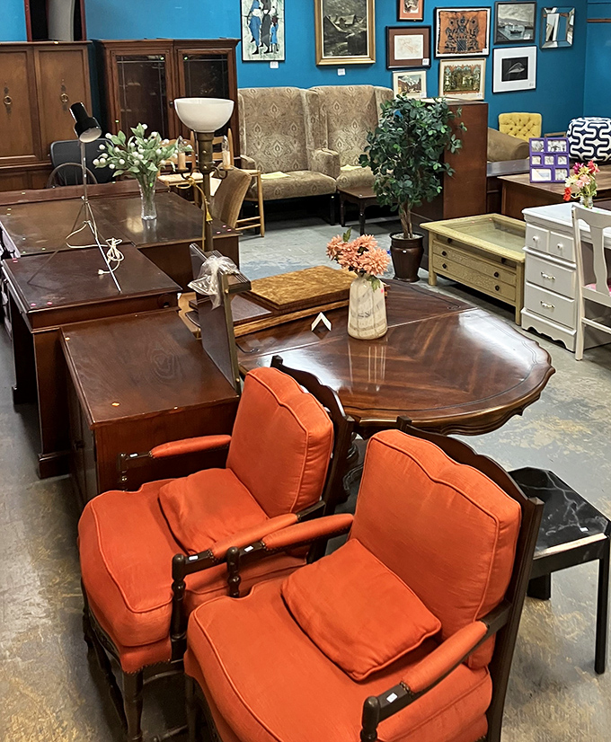 Mid-century meets modern in this furniture showroom where those tangerine armchairs practically beg to come home with you. Blue walls make the wood tones pop.