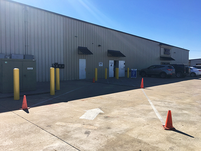 Yellow bollards guard the donation drop-off zone where your clutter becomes someone else's treasure&mdash;it's the circle of thrift.