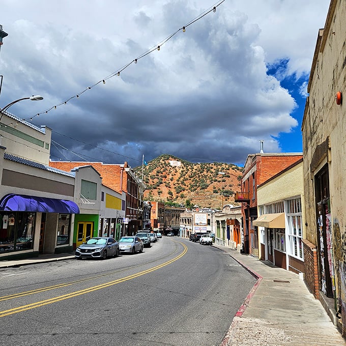 Storm clouds gather over Bisbee's main drag, creating dramatic lighting that photographers dream about and locals simply call "Tuesday afternoon in monsoon season."