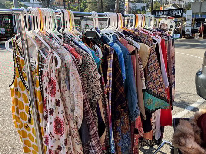 Vintage clothing racks bursting with patterns and possibilities. Each garment has survived decades to find its way to your closet.