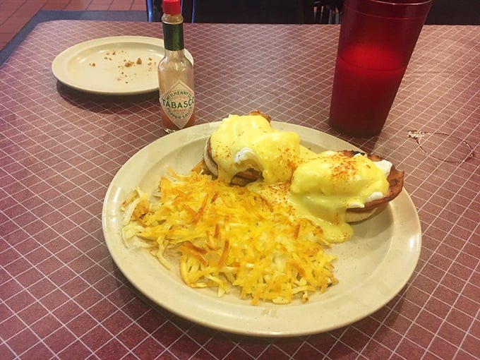 Eggs Benedict at a classic diner proves fancy doesn't require white tablecloths or a sommelier judging your coffee order.