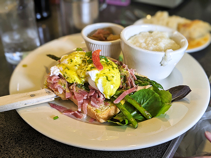 Not your average eggs Benedict – this ham-laden masterpiece with asparagus spears is what breakfast looks like when it dresses for a special occasion.