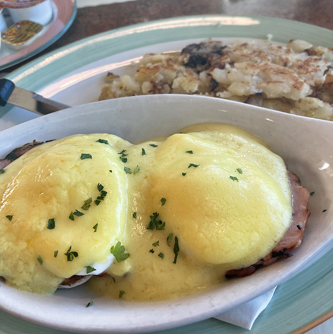 Eggs Benedict done right&mdash;pillowy poached eggs nestled on Canadian bacon with hollandaise sauce cascading down like a yellow waterfall of happiness.