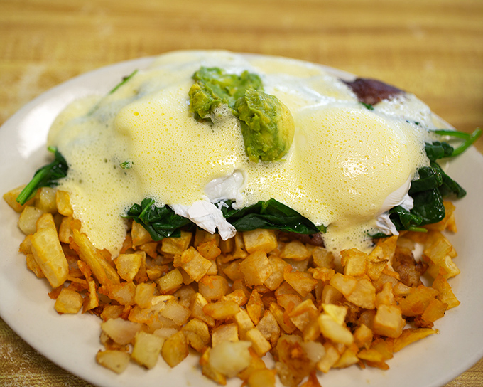 Eggs Benedict reimagined: perfectly poached eggs nestled on a bed of spinach with hollandaise that could make a French chef weep with joy.