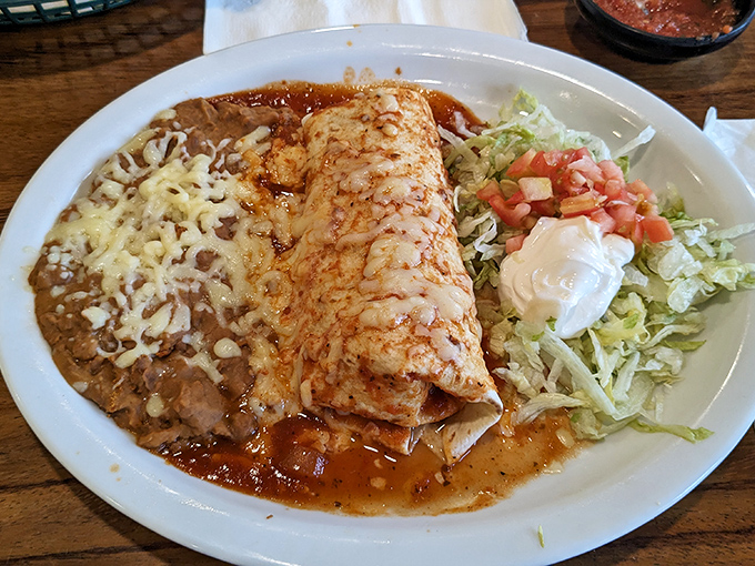 An enchilada swimming in sauce with a perfect cheese-to-tortilla ratio&mdash;proof that sometimes drowning is a good thing.
