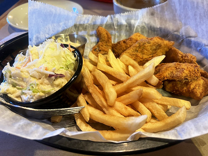 Golden-fried perfection with crispy fries and creamy coleslaw &ndash; proof that sometimes the simplest pleasures are the most profound. Comfort food that speaks fluent happiness.