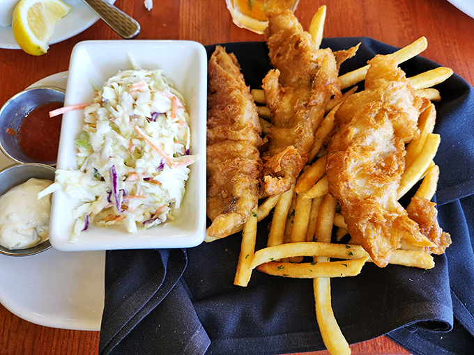 Fish and chips that would make a British pub jealous, with coleslaw so fresh it deserves its own real estate on the plate.