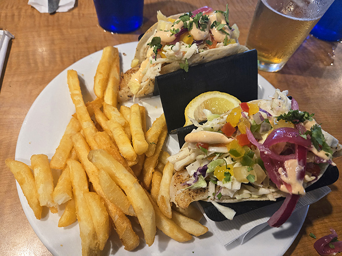 These fish tacos aren't just a meal; they're edible postcards from the Gulf, complete with crispy fries as their traveling companions.