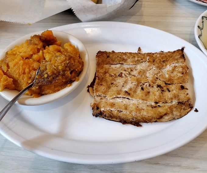A perfectly grilled salmon filet that would make Seattle proud, paired with sweet potato casserole that's practically dessert masquerading as a vegetable.