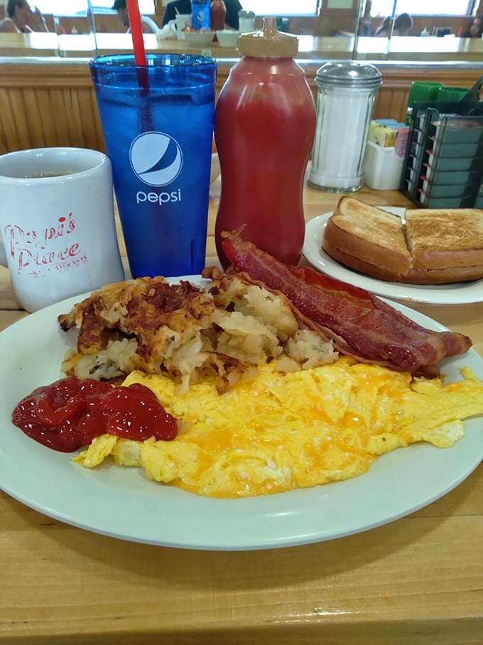 The breakfast trinity: golden eggs, crispy hash browns, and bacon cooked to that perfect point between chewy and crisp. Add toast and you've got religion.