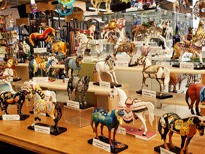 A miniature cavalry of decorative horses stands at attention, each figurine telling its own story through intricate paintwork and whimsical designs.