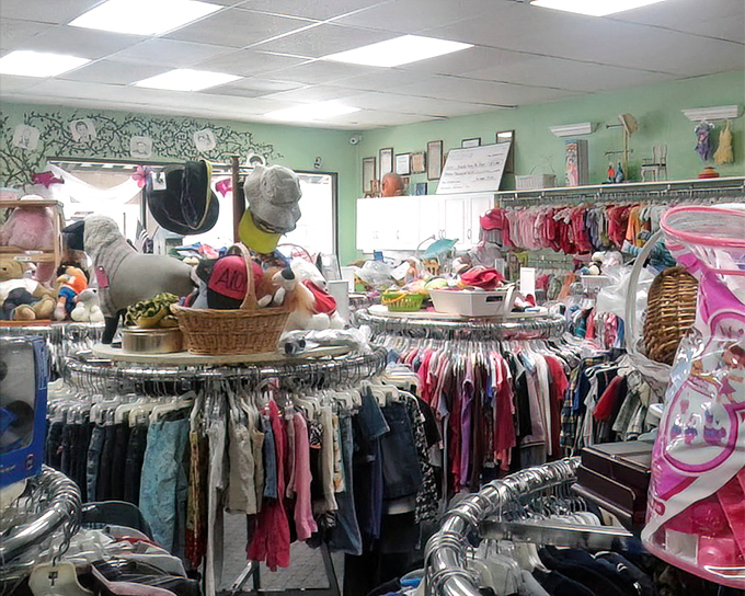 Children's clothing paradise! Those tiny shirts and pants are organized with military precision, topped with stuffed animals keeping watch over their miniature fashion kingdom.