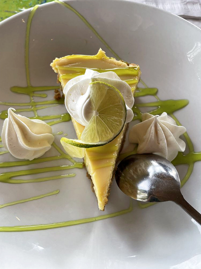 Key lime pie that strikes the perfect balance between tart and sweet, topped with whipped cream and a lime slice for good measure.