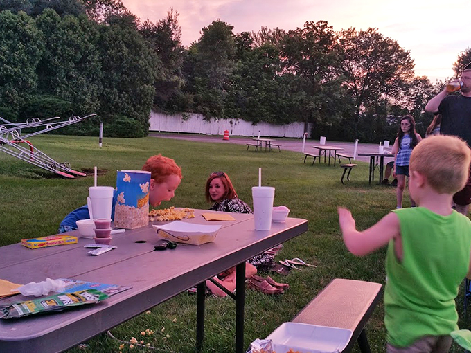 Picnic tables become command centers for families plotting their perfect movie night, complete with strategic popcorn deployment and blanket arrangements.