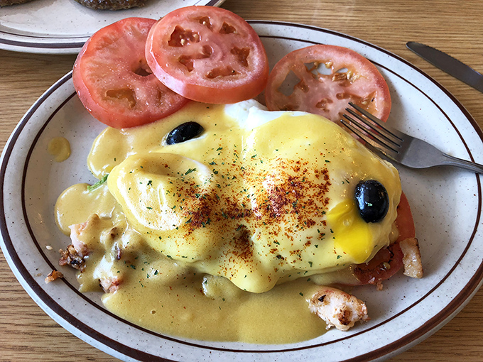 Eggs Benedict elevated to art form&mdash;where hollandaise sauce cascades like a yellow waterfall over perfectly poached promises.
