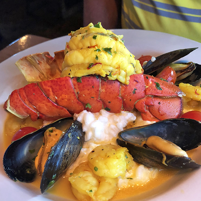 The lobster tail that launched a thousand return visits. Butter-bathed perfection resting on a cloud of creamy grits with mussels standing guard.