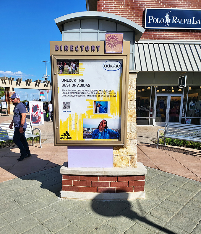 The mall directory stands as a shopping GPS, helping lost souls navigate their way to retail salvation at stores like Polo Ralph Lauren.