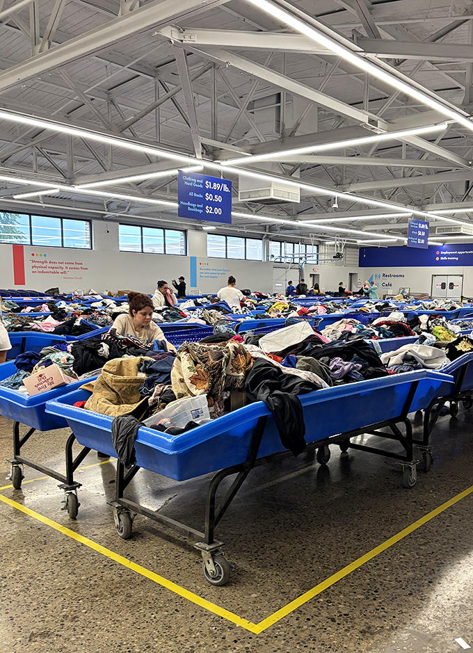 The pricing sign tells the whole story: $1.89 per pound for clothing. That designer jacket? Probably costs less than your morning latte.