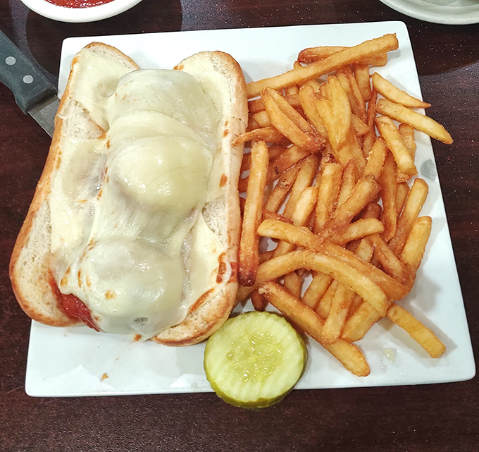 This meatball sandwich, draped in melted cheese and served with crispy fries, is the comfort food equivalent of a warm hug.
