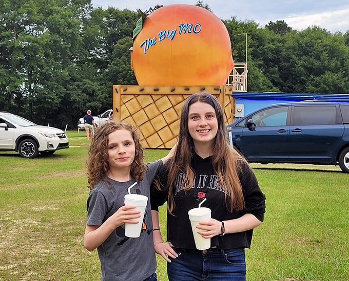 The giant peach stands as The Big Mo's quirky landmark, a sweet nod to local agriculture that's become a beloved photo spot.