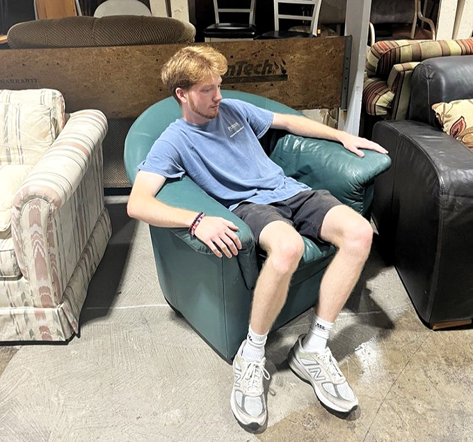 Testing chairs is encouraged here &ndash; this young shopper knows comfort shopping when he experiences it firsthand.