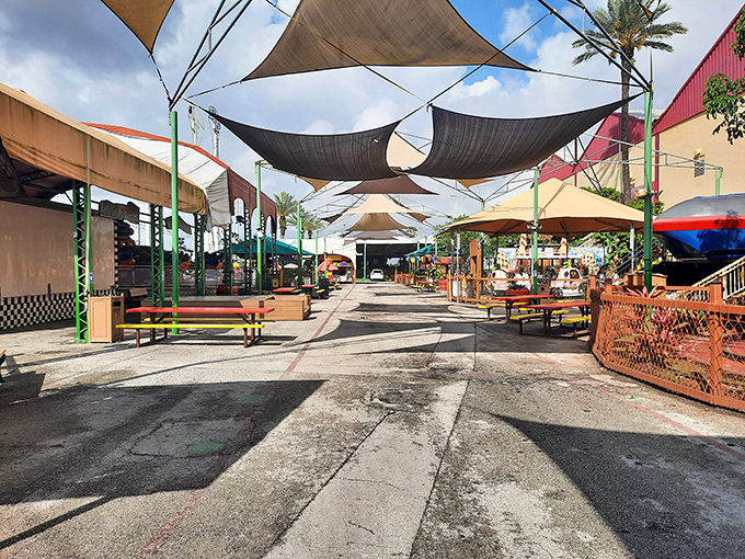 Shade sails provide merciful relief from the Florida sun in this outdoor gathering space where shoppers pause between treasure-hunting expeditions.