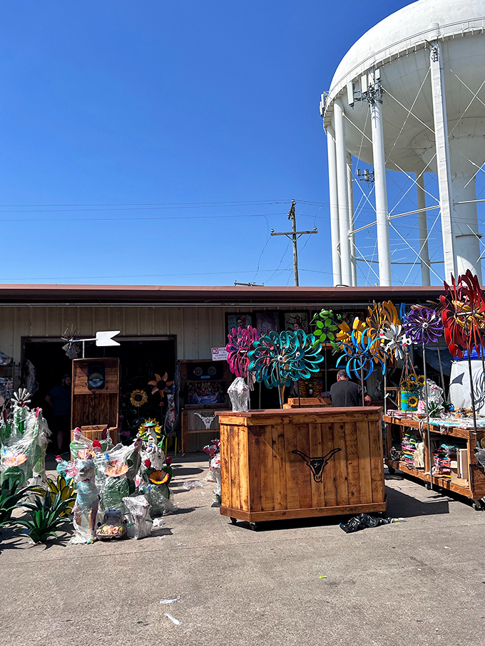 Garden ornaments and metal art catch the sunlight outside this vendor's stall, where your backyard's personality upgrade is just a haggle away.