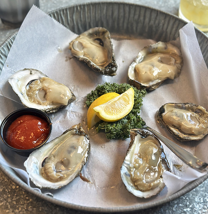 These oysters aren't just served&mdash;they're presented like the pearls they truly are. Fresh, briny, and ready for their close-up with lemon and cocktail sauce.