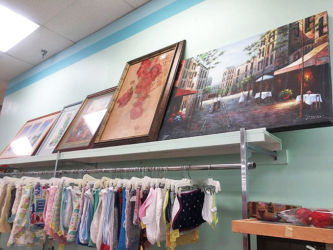 Art that once graced someone else's walls awaits a second chance at admiration, while baby clothes below remind us how quickly little ones outgrow everything.