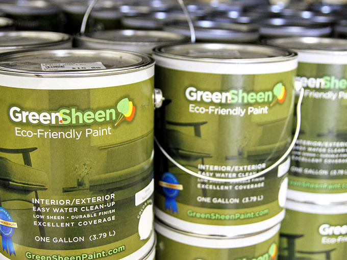 Eco-friendly paint cans standing at attention, ready to transform your "meh" walls into "magnificent" without the toxic relationship with your lungs.