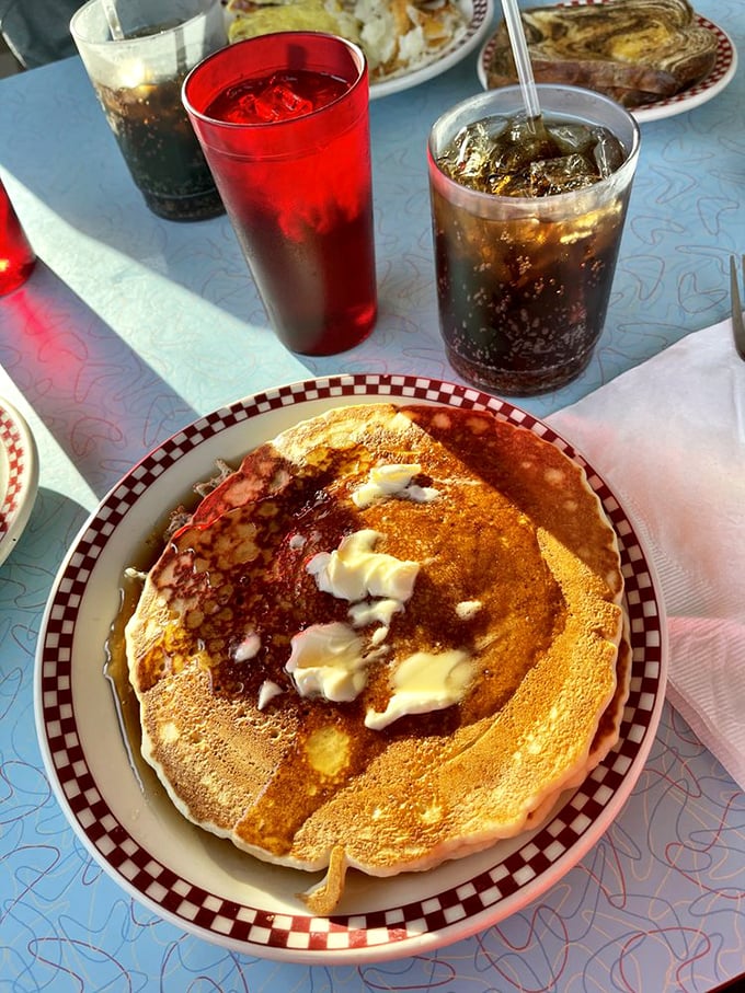 This pancake isn't just large&mdash;it's the size of a small frisbee. Butter melting into those perfect golden divots is breakfast poetry in motion.