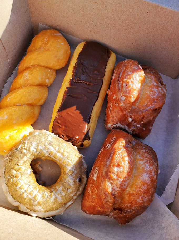 Box of joy: Chocolate glazed donuts and maple bars nestled together like old friends catching up over coffee, waiting for their moment of glory.