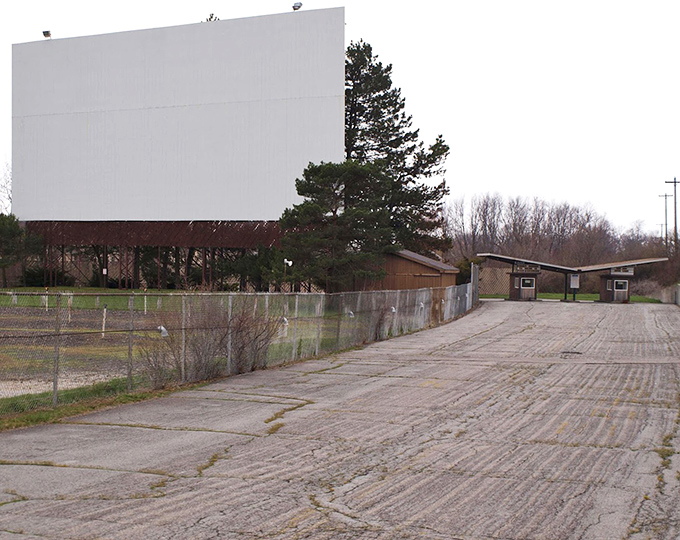 Behind the scenes at the drive-in, where the massive blank screen waits patiently for darkness. Cinema's ultimate blank canvas, ready for stories to unfold.