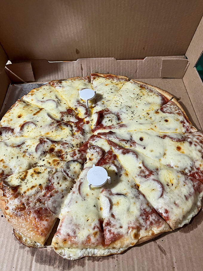 The pepperoni pizza arrives in its cardboard chariot, those little cups of pepperoni holding flavor-packed pools of savory oil like tiny flavor hot tubs.