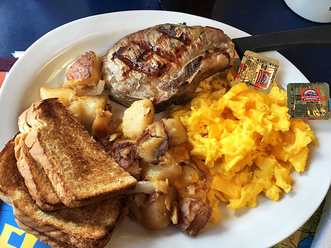 Breakfast of champions: golden hash browns, sunshine-yellow eggs, and a pork chop that makes you wonder why you ever bothered with cereal.